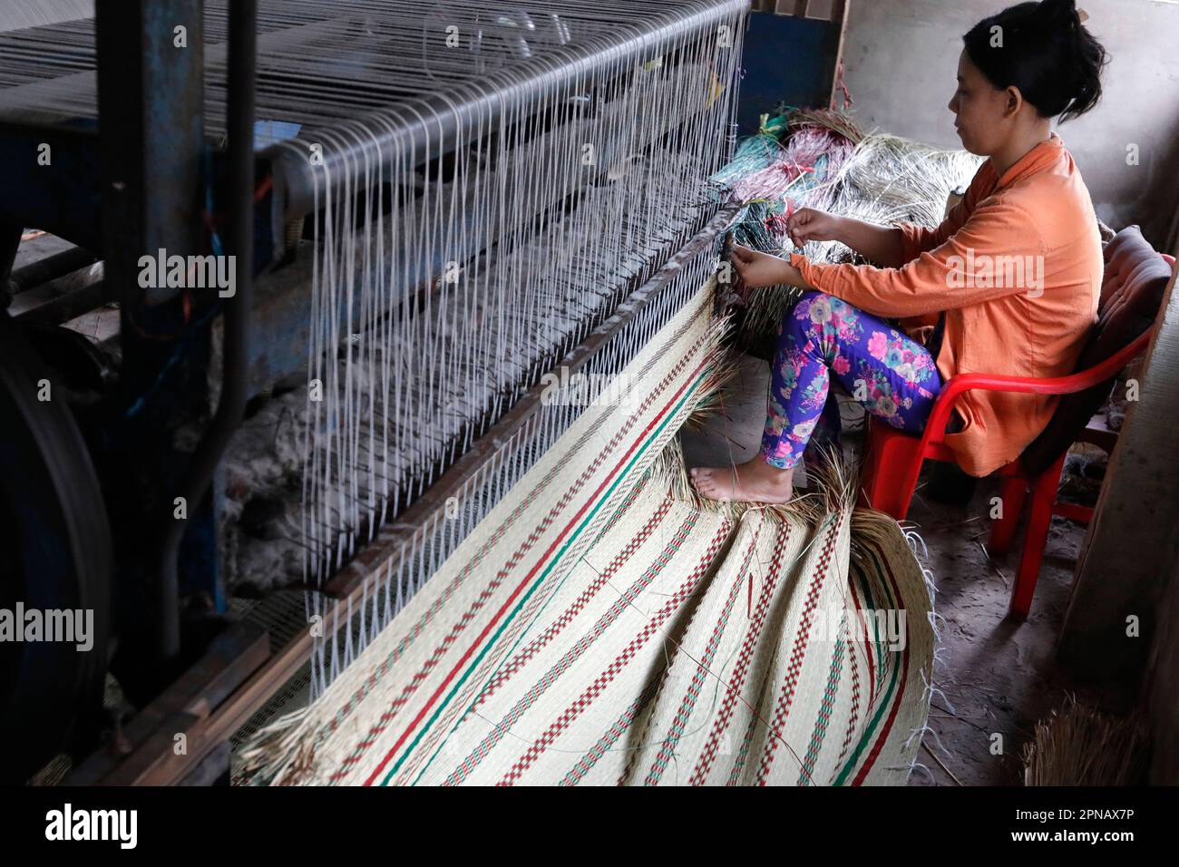 Traditional bamboo and hemp mat factory. Vietnamese woman working on a ...
