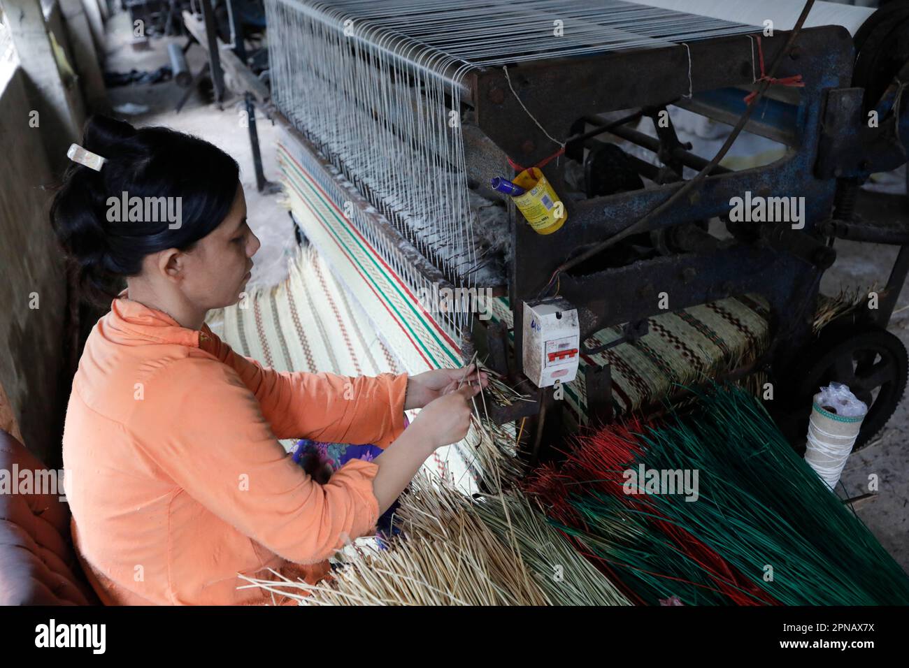 Traditional bamboo and hemp mat factory. Vietnamese woman working on a ...