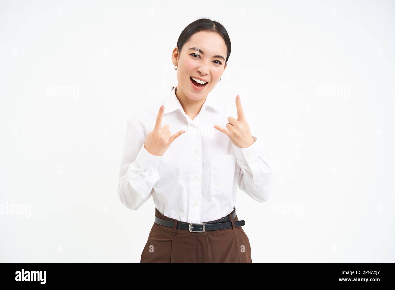 Excited smiling businesswoman, asian female employee, has fun, shows ...