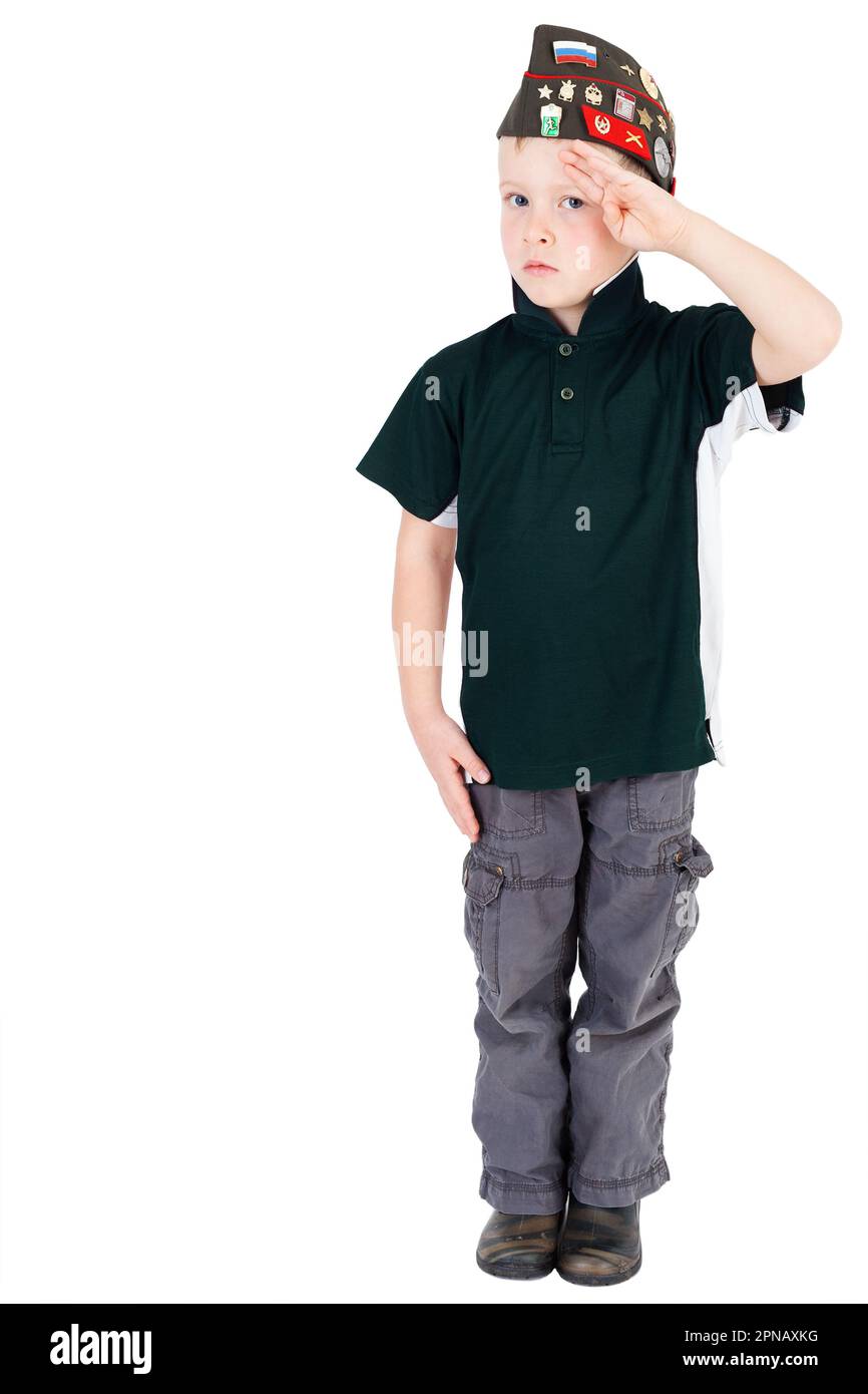 Young caucasian boy saluting in respect looking front on playing ...