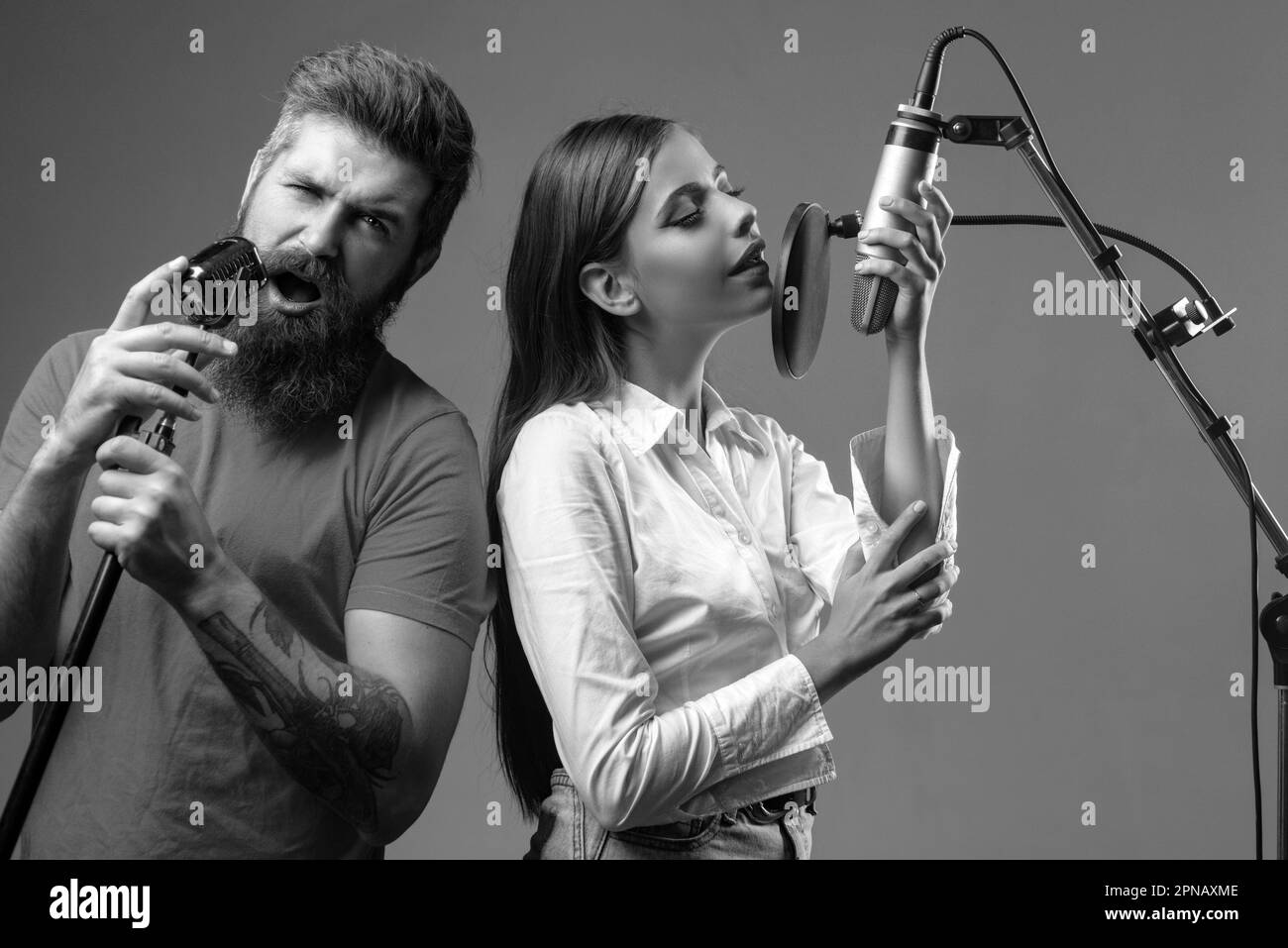 Karaoke singers couple. Woman and man singing with music microphone ...