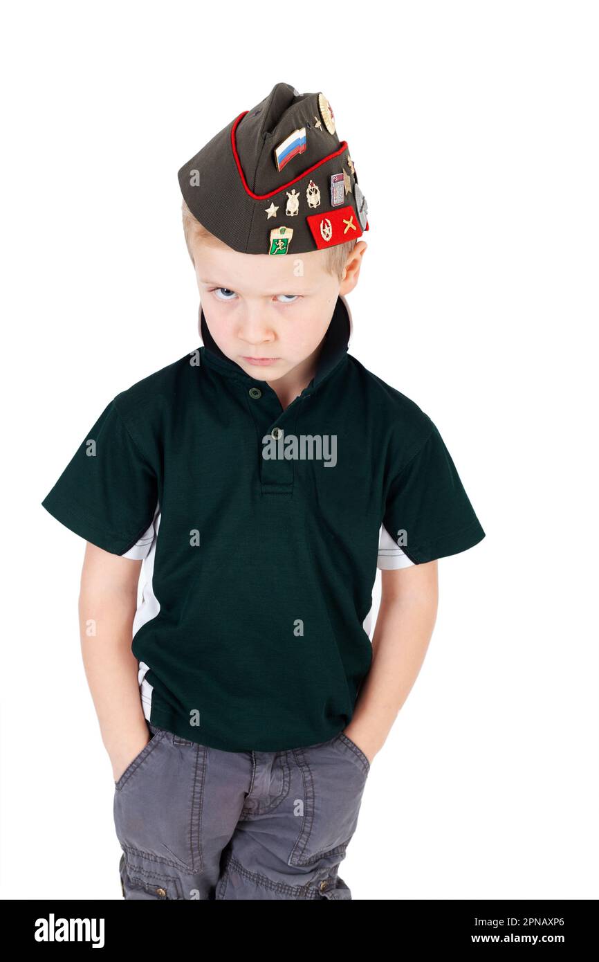 Scowling with one eye open - young caucasian boy playing dressups in ...