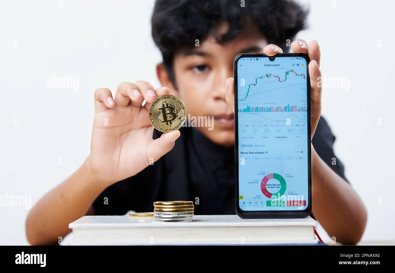 Little boy holding gold Cryptocurrencies coin with isolated white ...