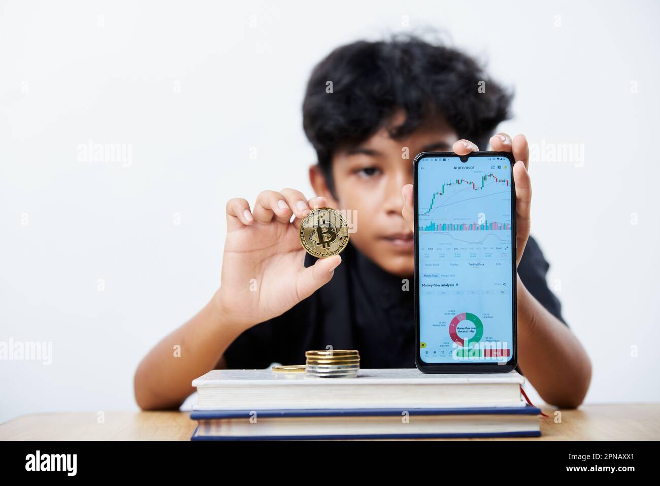 Little boy holding gold Cryptocurrencies coin with isolated white ...