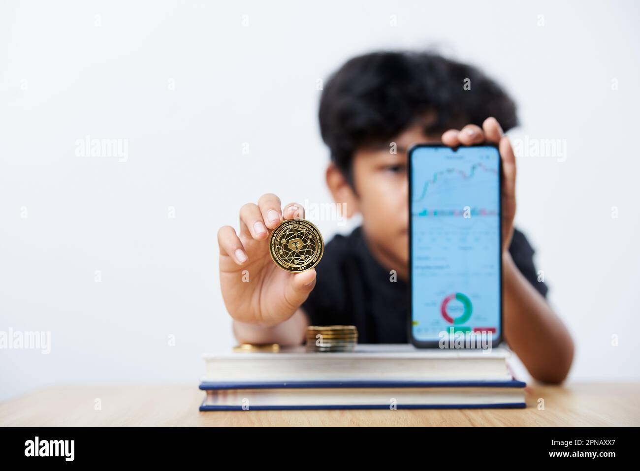Little boy holding gold Cryptocurrencies coin with isolated white ...