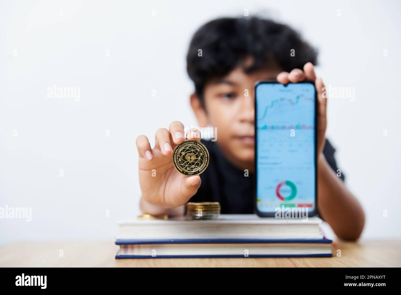 Little boy holding gold Cryptocurrencies coin with isolated white ...