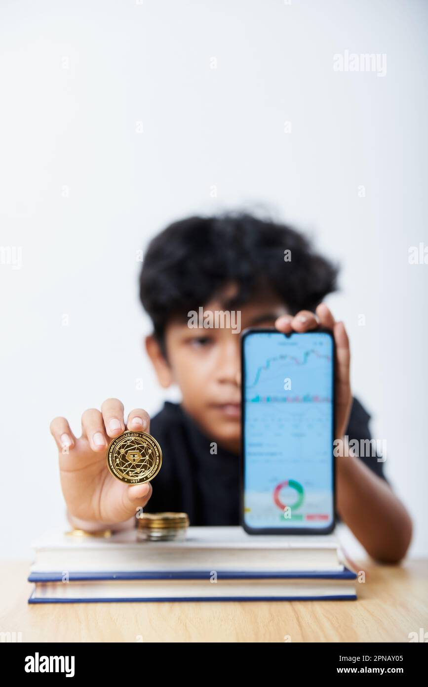 Little boy holding gold Cryptocurrencies coin with isolated white ...