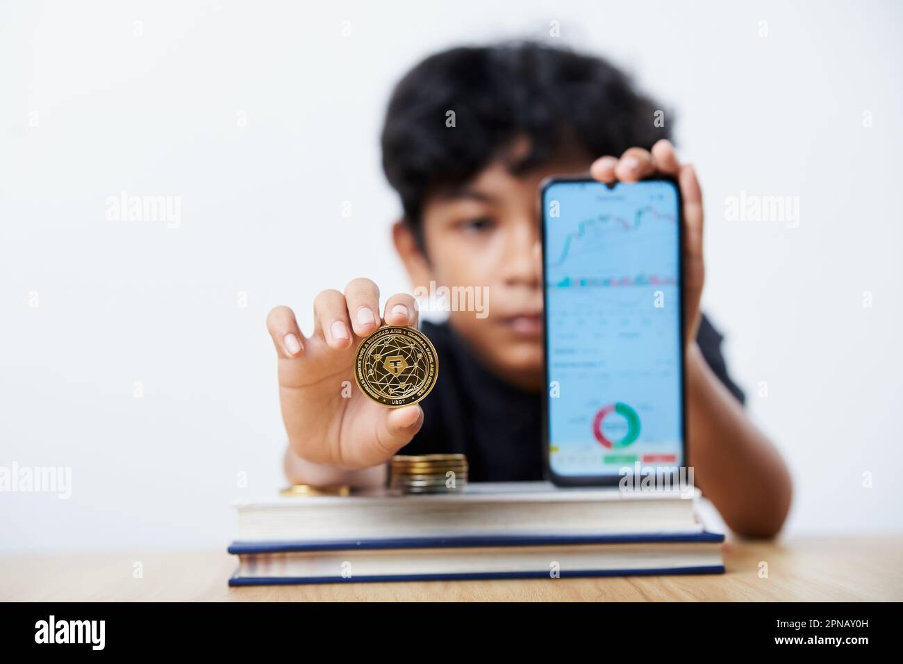 Little boy holding gold Cryptocurrencies coin with isolated white ...