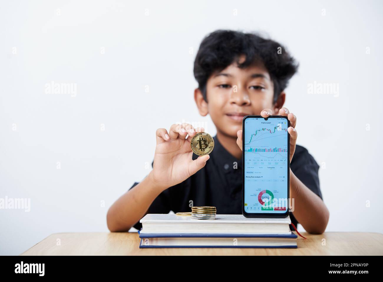 Little boy holding gold Cryptocurrencies coin with isolated white ...