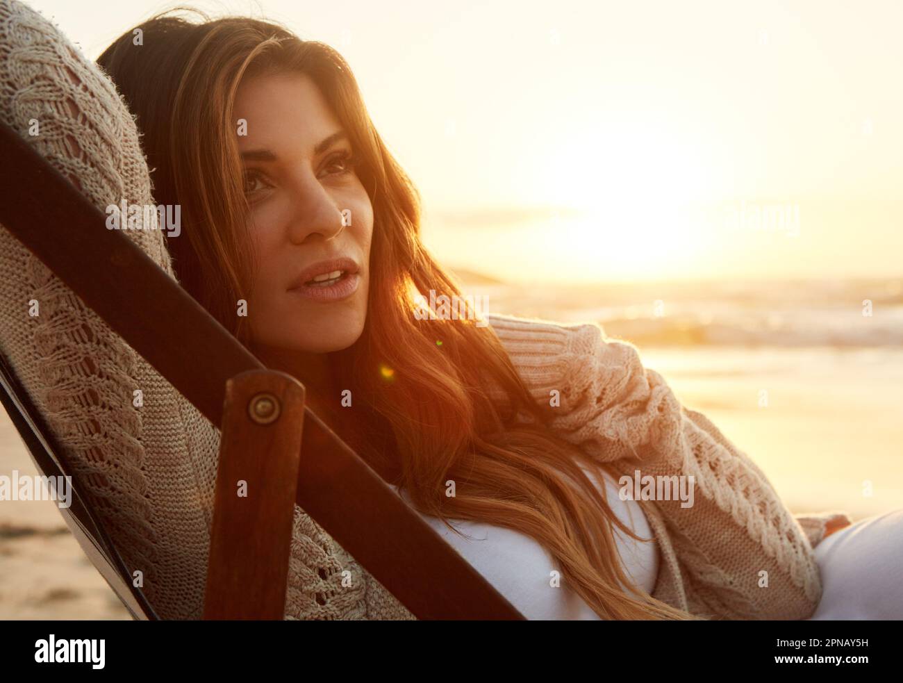 The calm of nature is what I enjoy the most. a young woman relaxing on ...