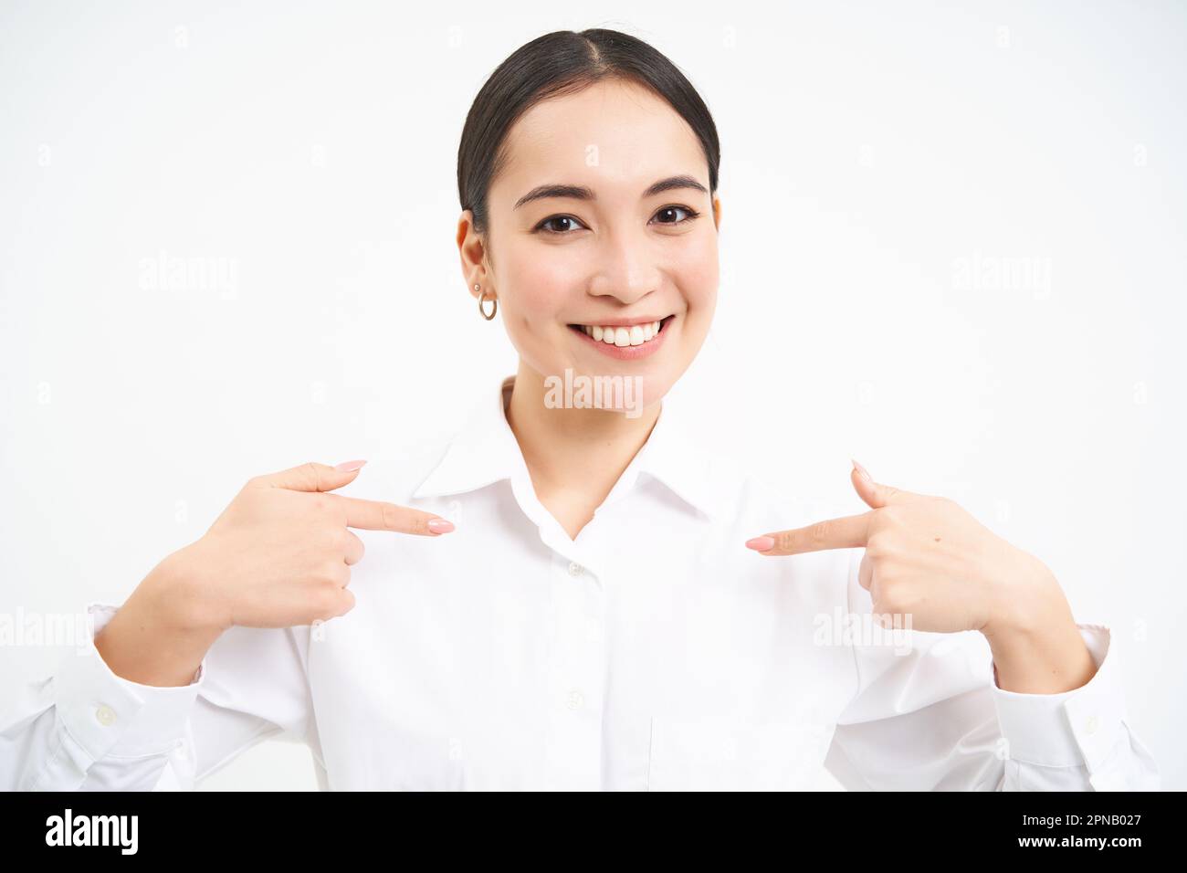 Asian businesswoman points at herself with confidence, looks like ...