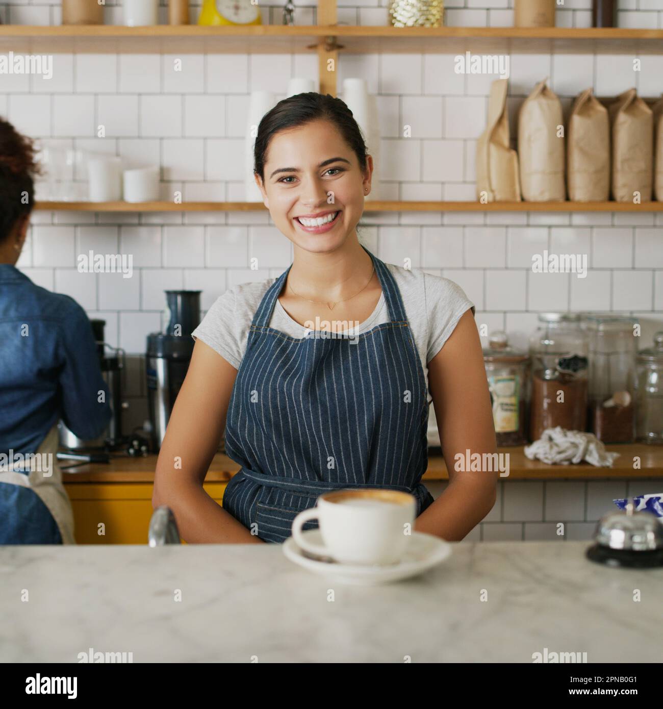 Serving the best coffee in town with a big smile. Portrait of a young ...