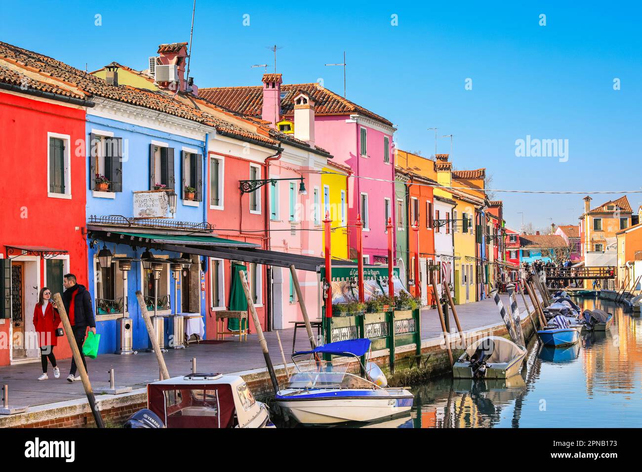 Burano island, colourful houses, people and shops by the canal, Via ...