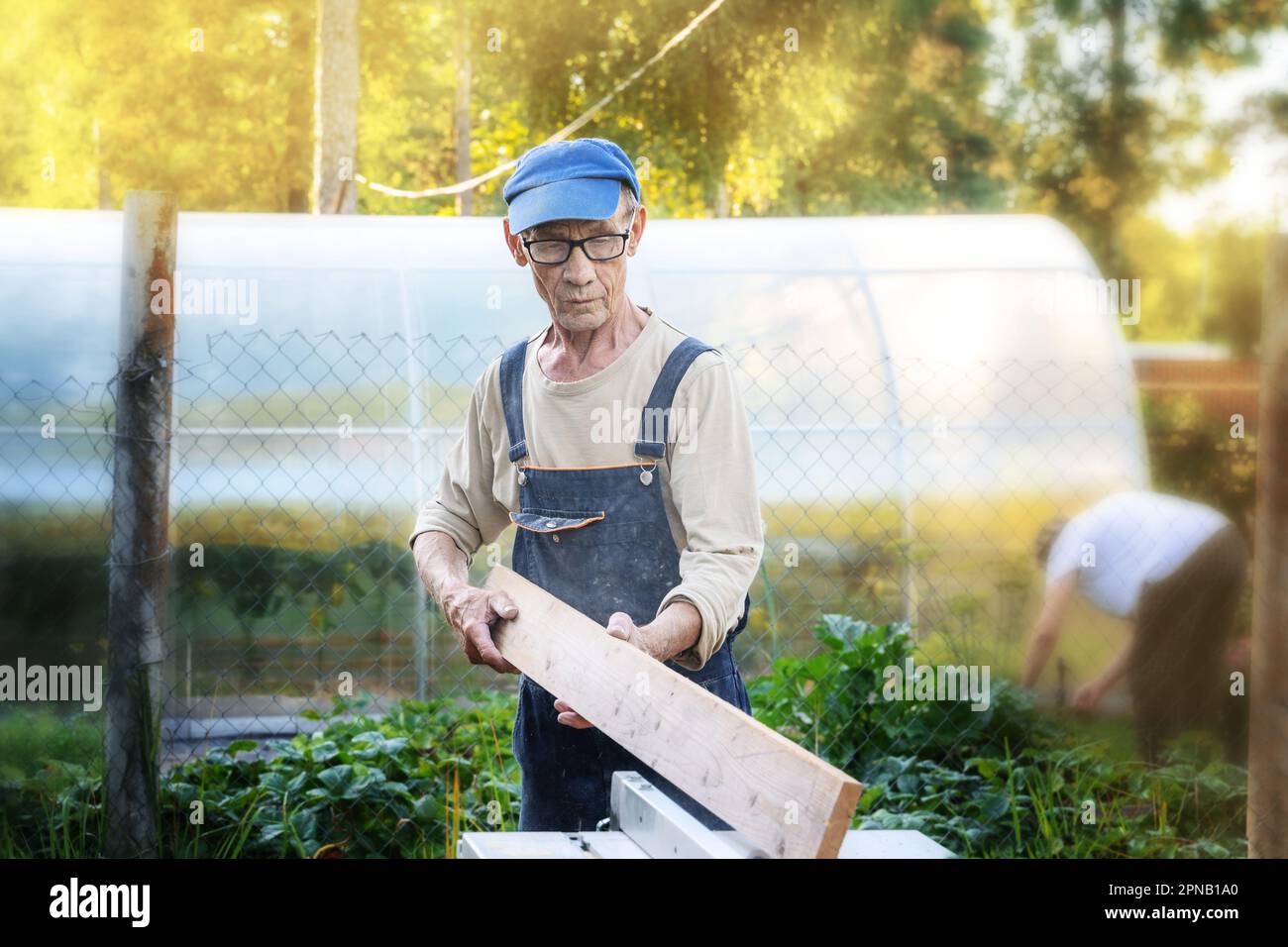 Work on the infield. Do it yourself. A carpenter processes wooden ...