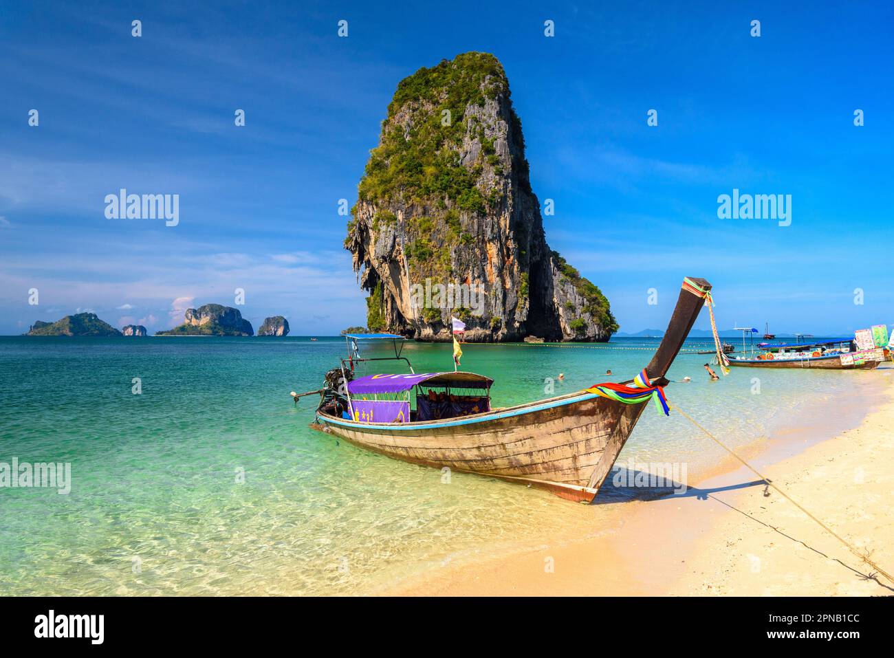 Long tail boats and cliff rock in azure water, Ko Rang Nok, Ao Phra ...