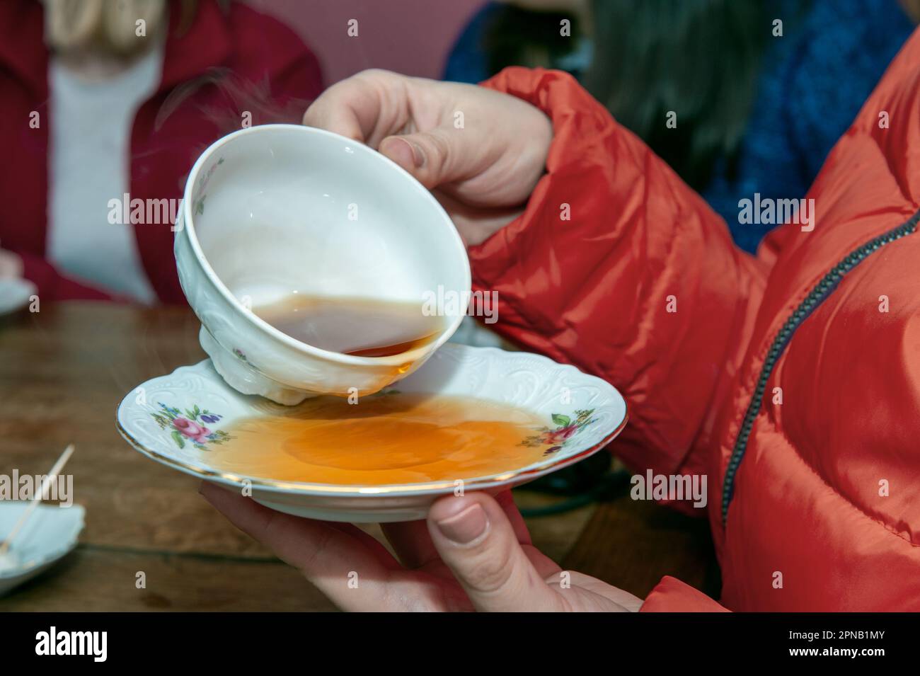 Tea drinking from a saucer, an old Russian tradition. A woman drinks ...