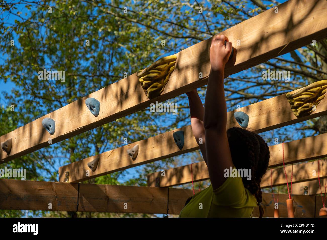 a female participant in an obstacle course during one of the races, ocr ...