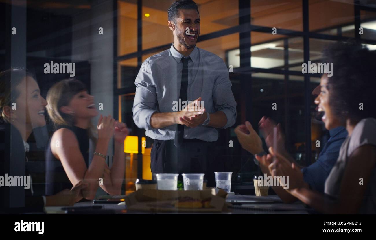 Congratulations team. a diverse group of businesspeople clapping after ...