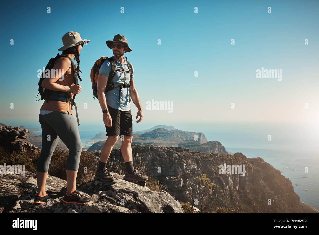 All in a days hike. a man and woman hiking up a mountain Stock Photo ...