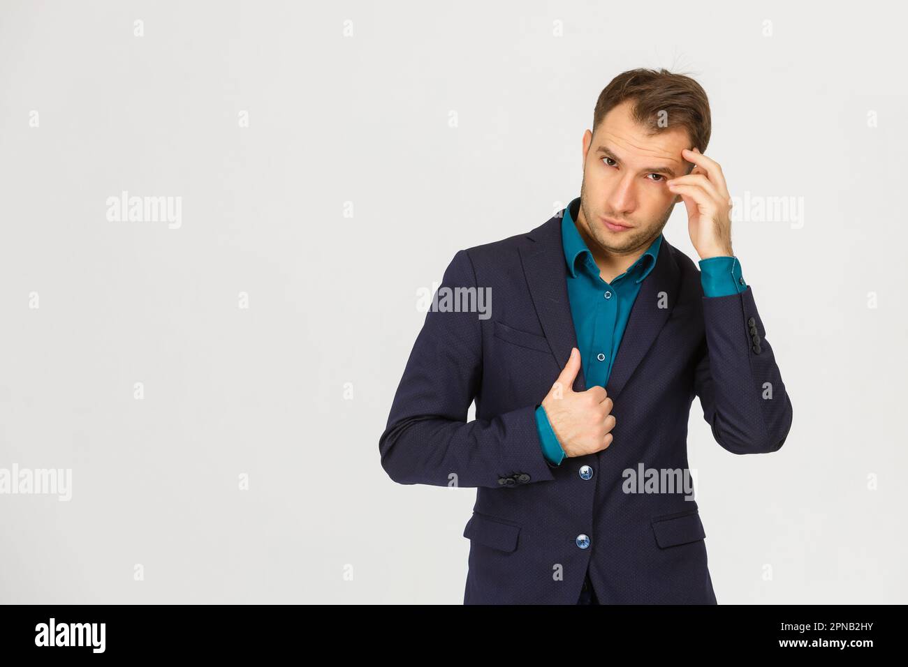 Young man having doubts and with confuse face expression while ...