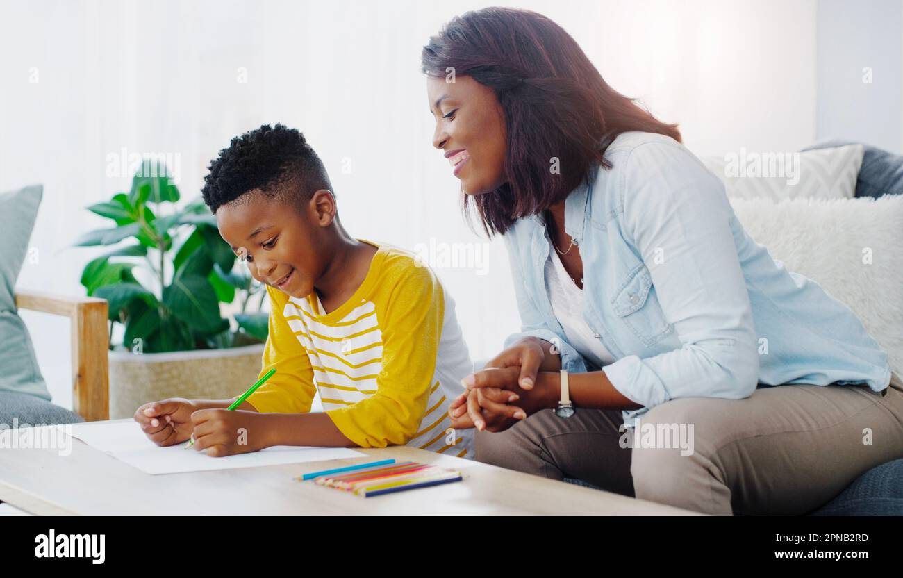 Mothers always know best. a mother helping her young son with his homework at home Stock Photo ...