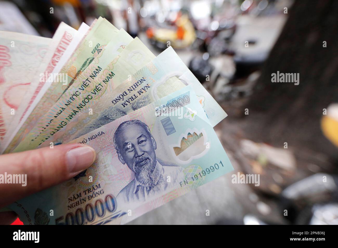 Vietnamese currency, the Dong, bank notes held by woman, economy ...