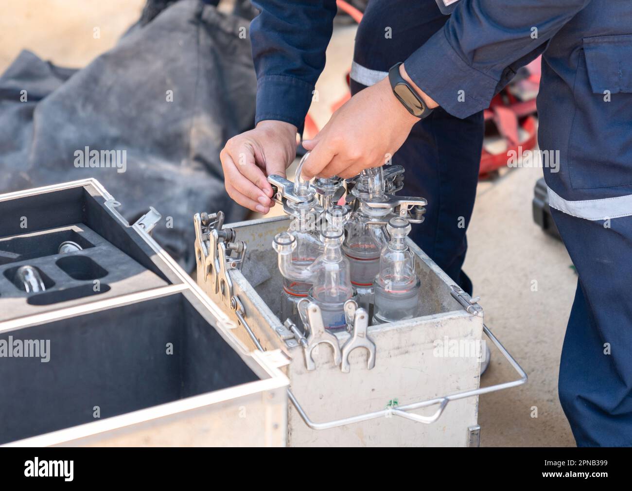 Environment officer connect test tube for sampling air from stack of ...