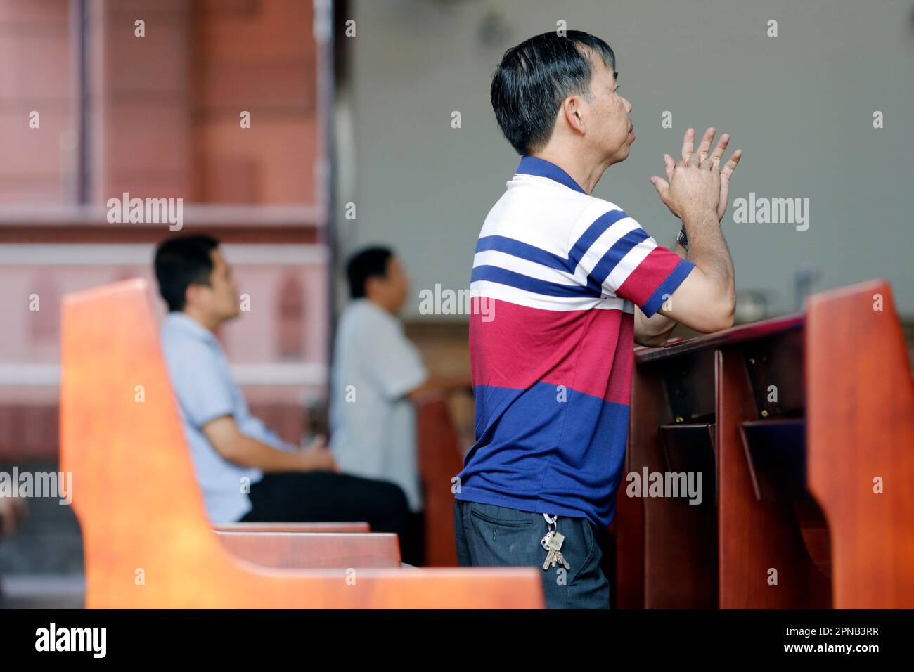 Our Lady of Fatima church. Catholic man praying. Ho Chi Minh City ...