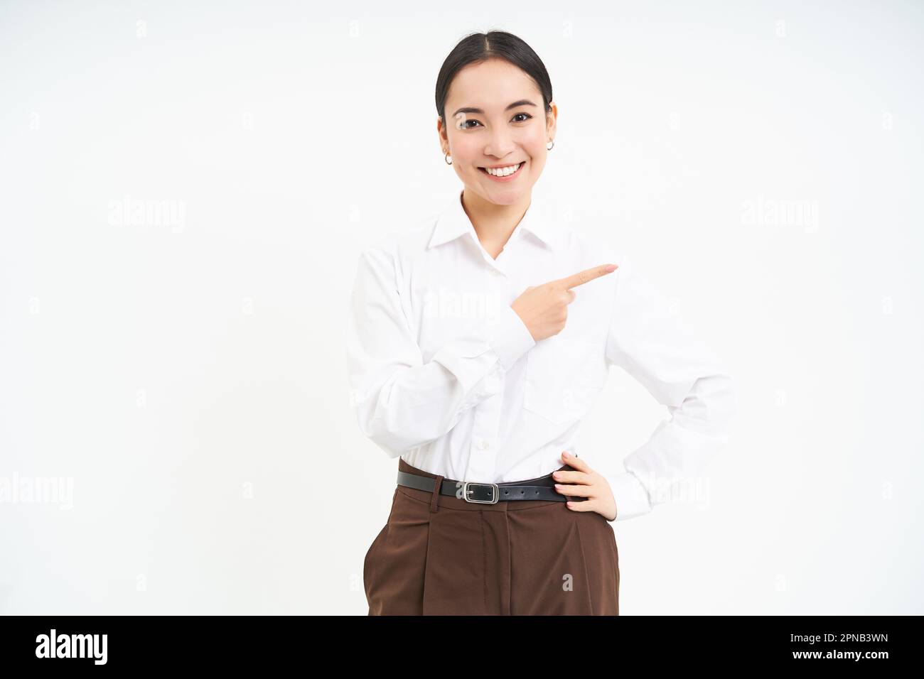 Portrait of smiling korean woman, lady boss points finger right, shows ...