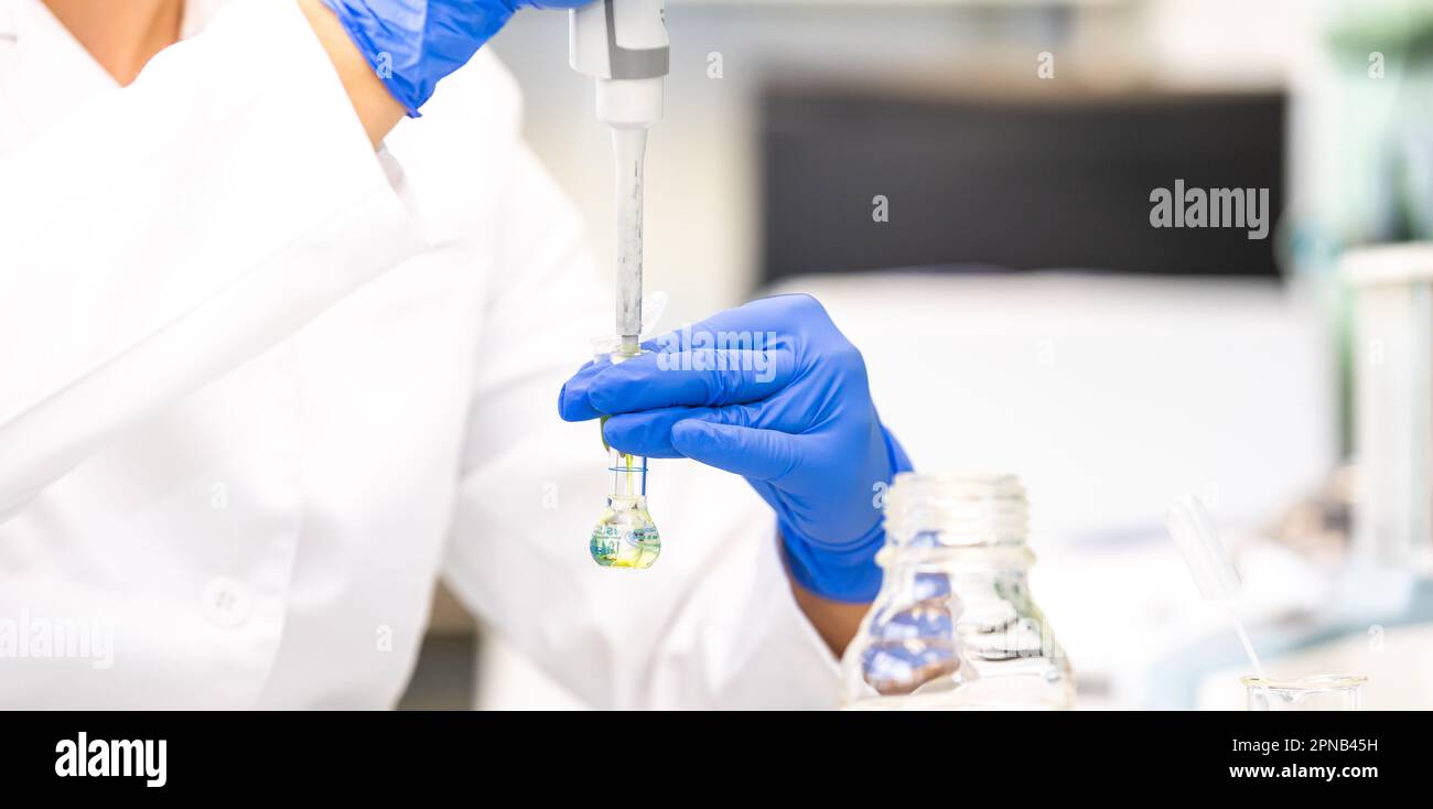 Young woman scientist holding test tube with lab glassware, science ...