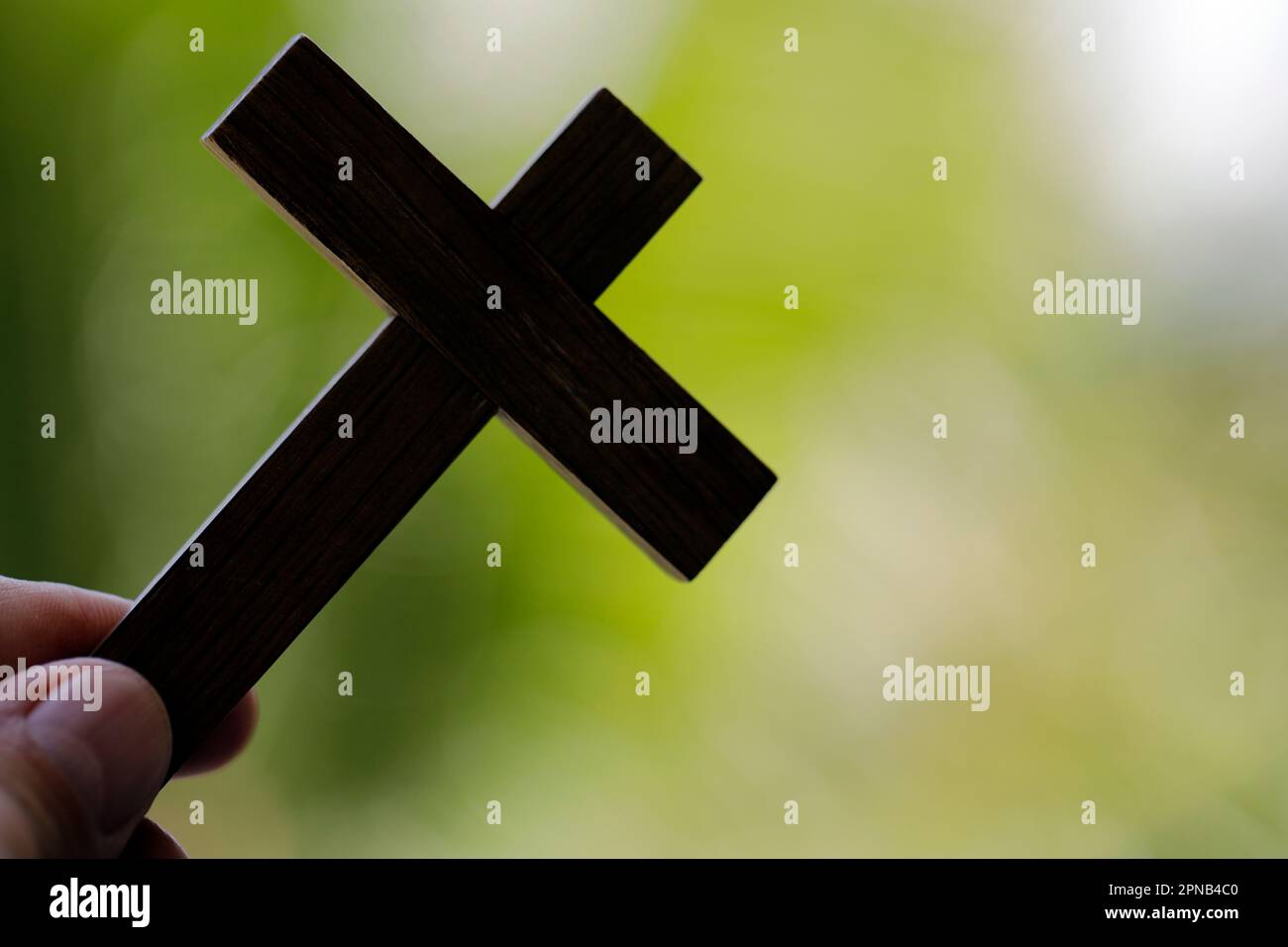 Hand holding wooden cross. Concept for religion, faith and prayer Stock ...