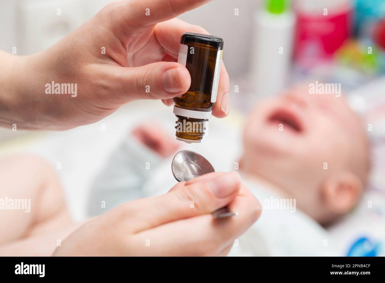 Mother drips drops from colic in the tummy of a small child Stock Photo ...