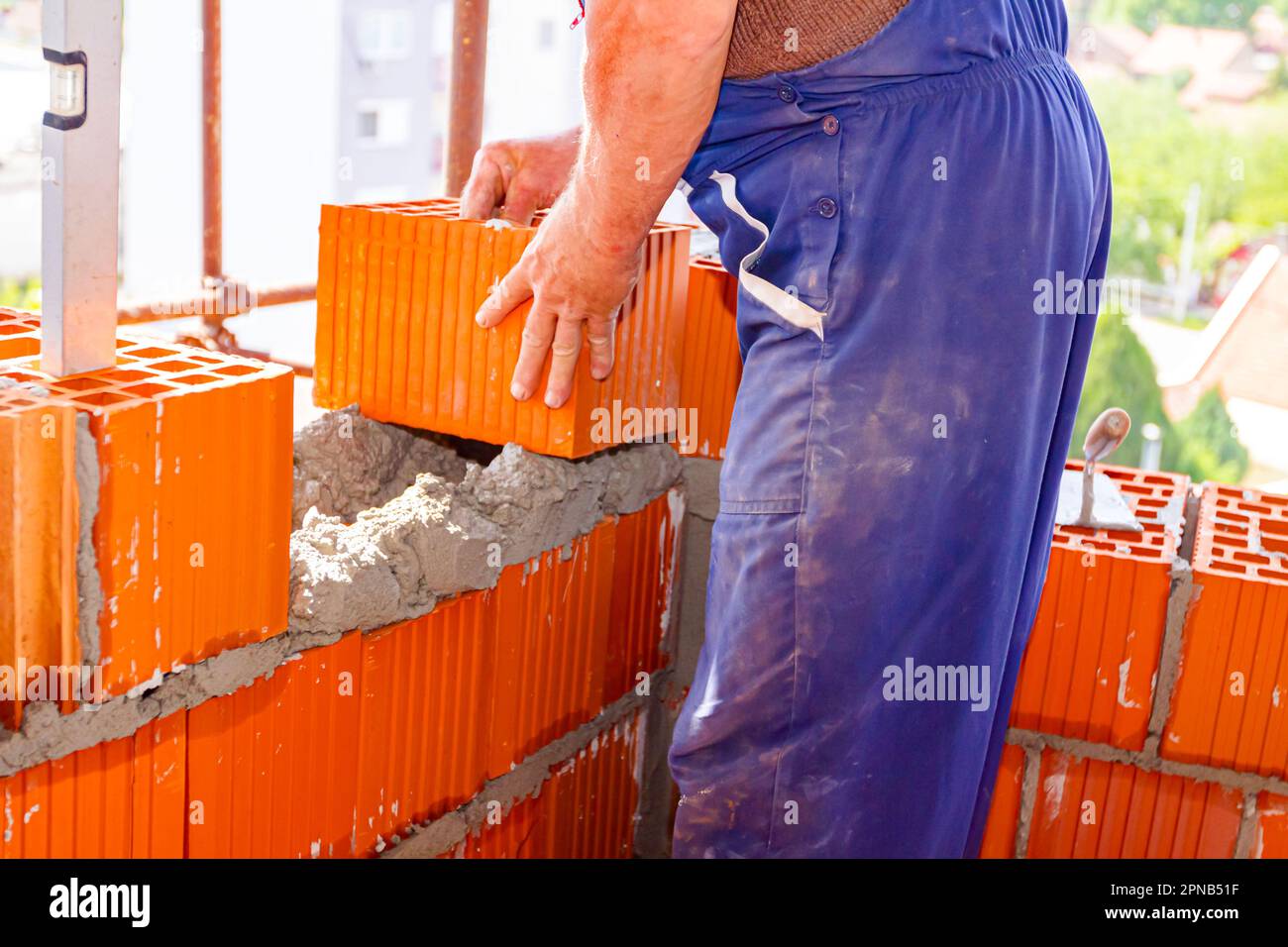Spirit level for control measurement stuck in hollow of red ceramic ...