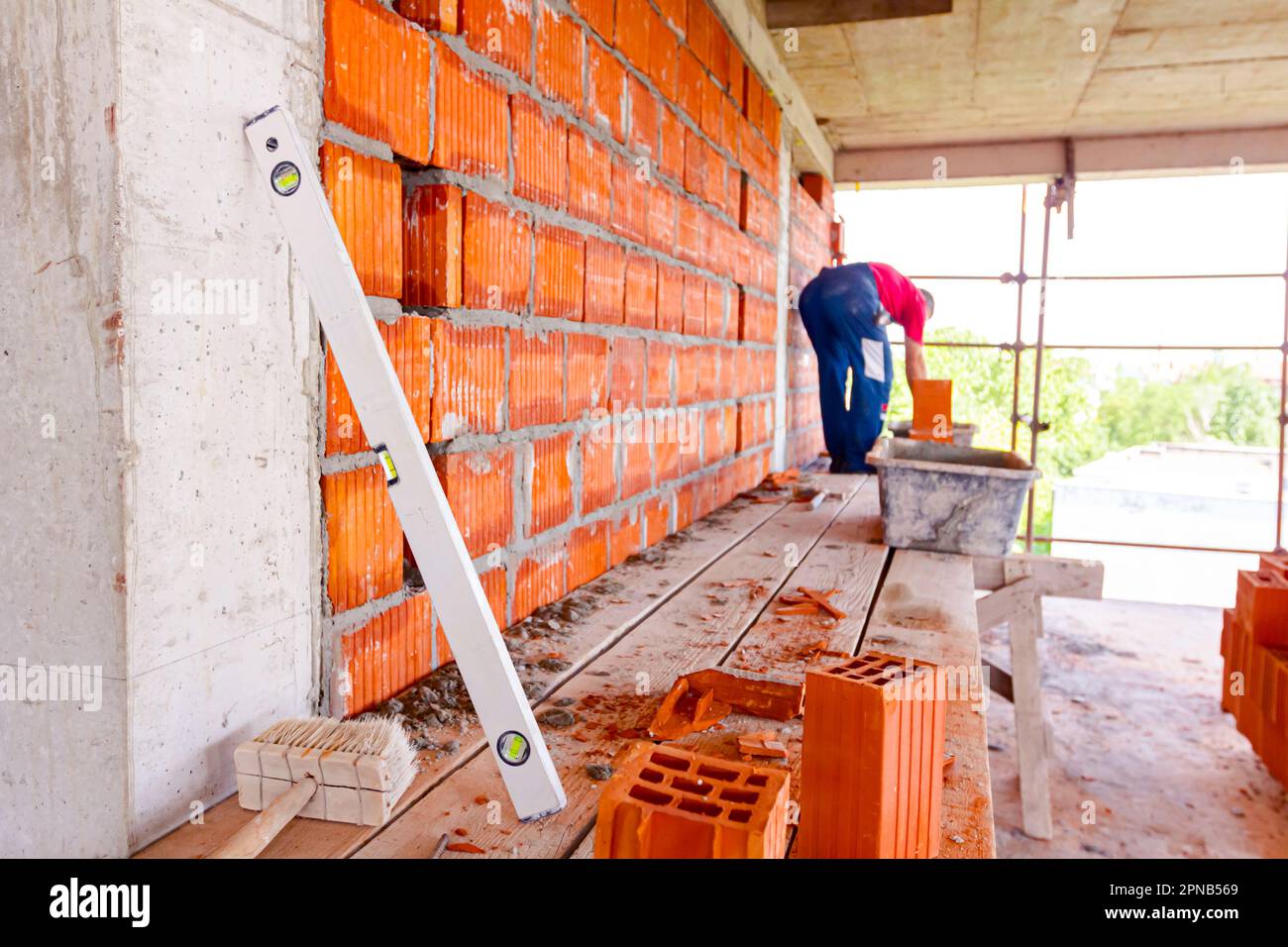 Spirit level for control measurements leaned to concrete pillar and a ...