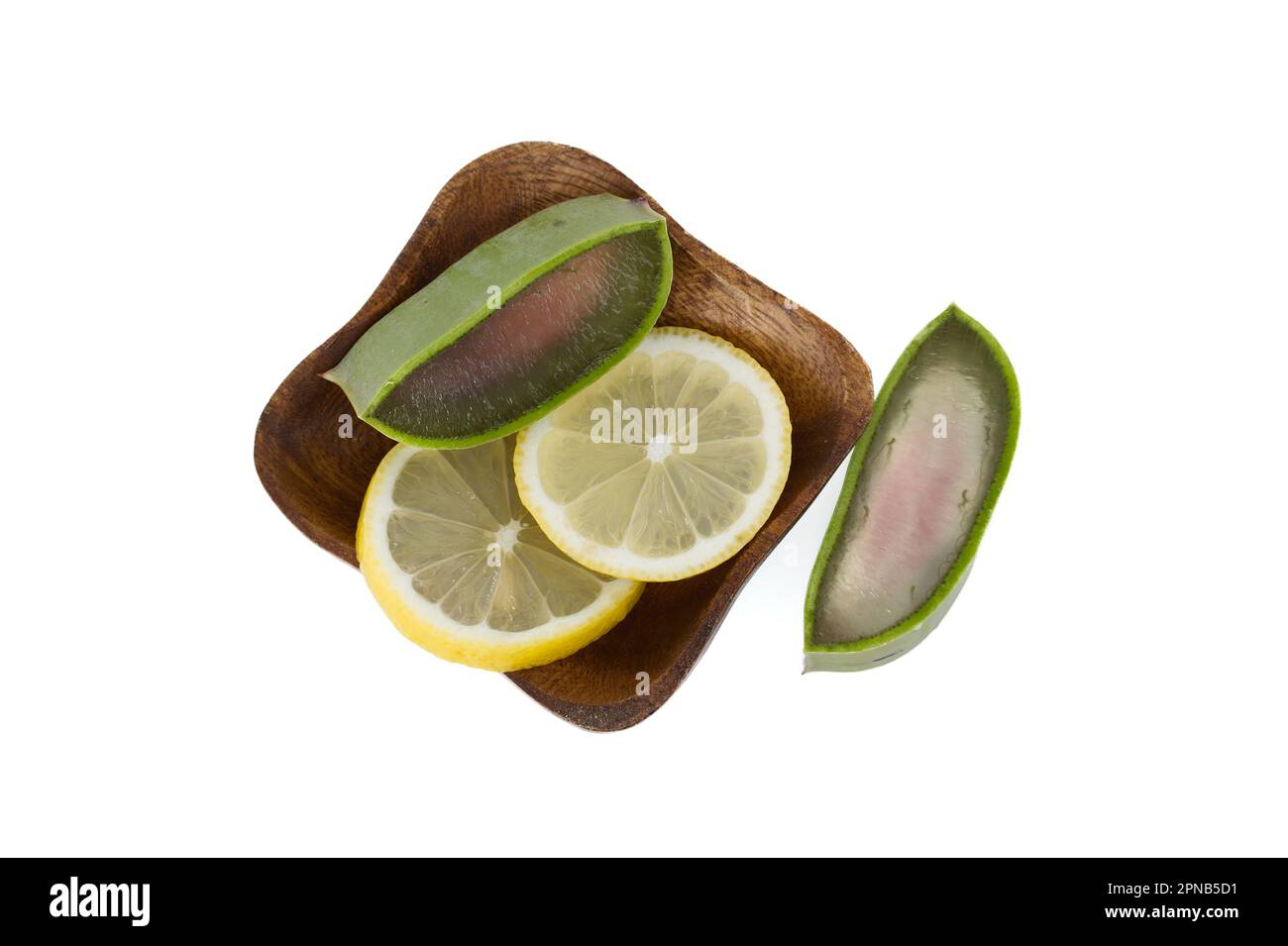 Aloe Vera leaf and lemon slices in a wooden plate isolated on white ...