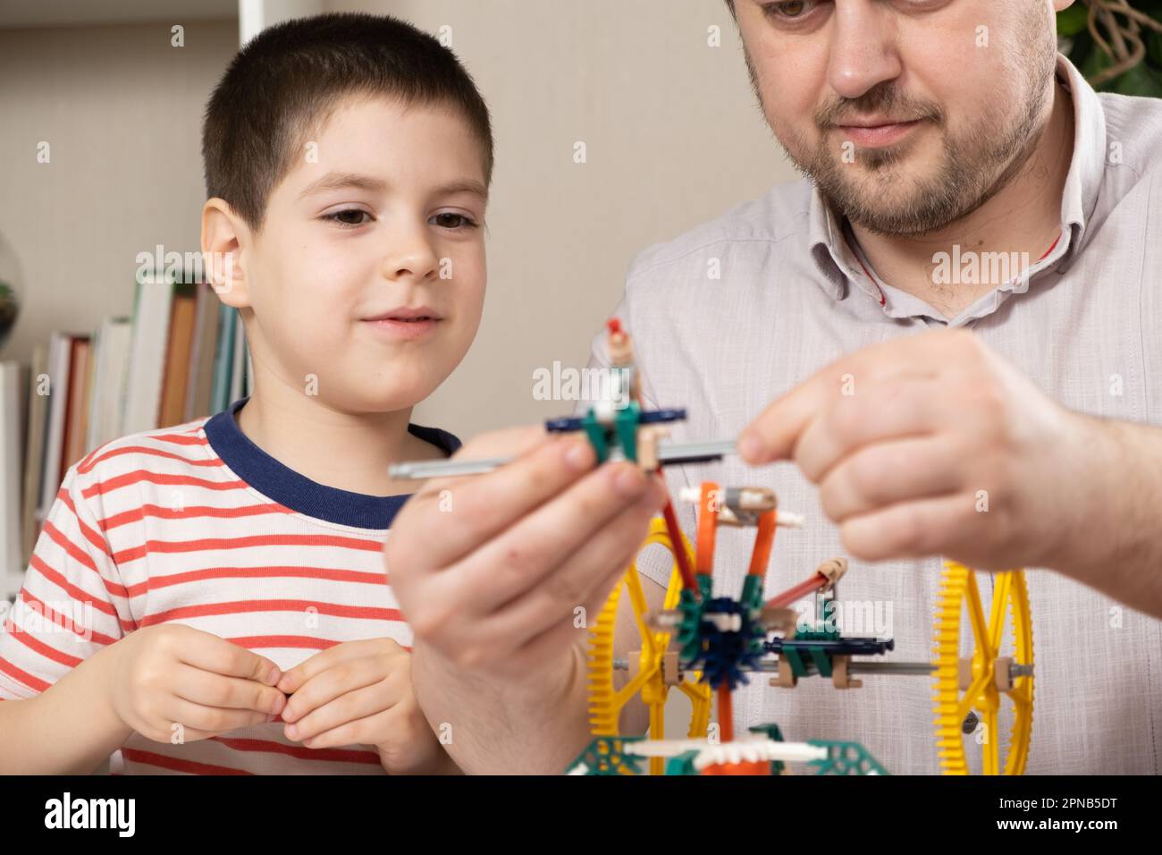 Dad and son build figures from the constructor. Spending time together ...
