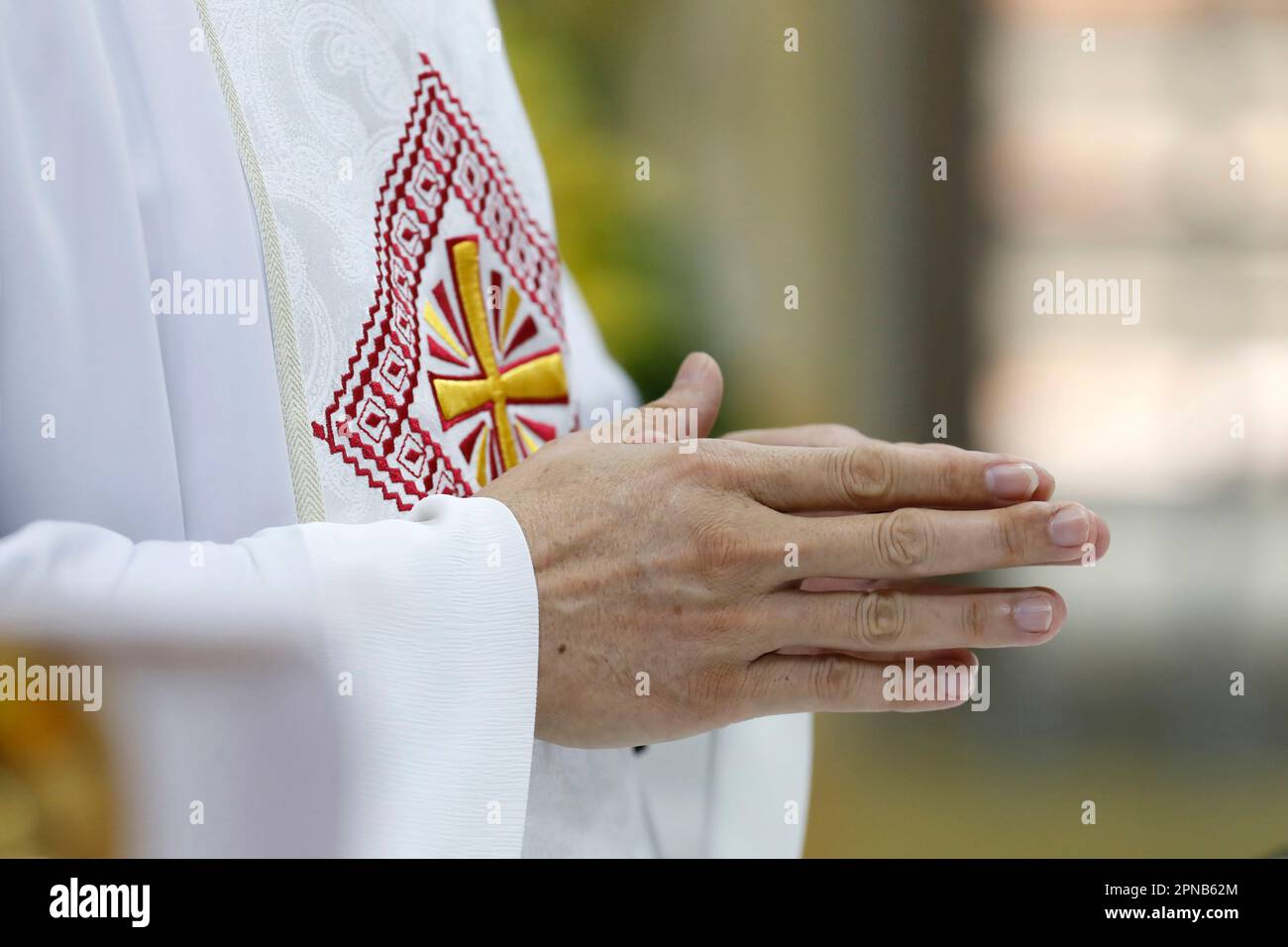 Sunday mass. Roman catholic church. Priest praying. Close-up on hands ...