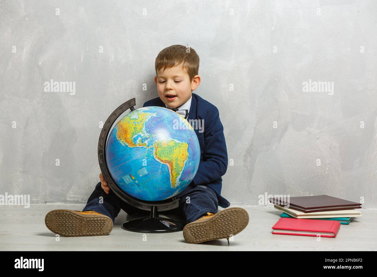 Cute caucasian schoolboy sits in the classroom at elementary school ...