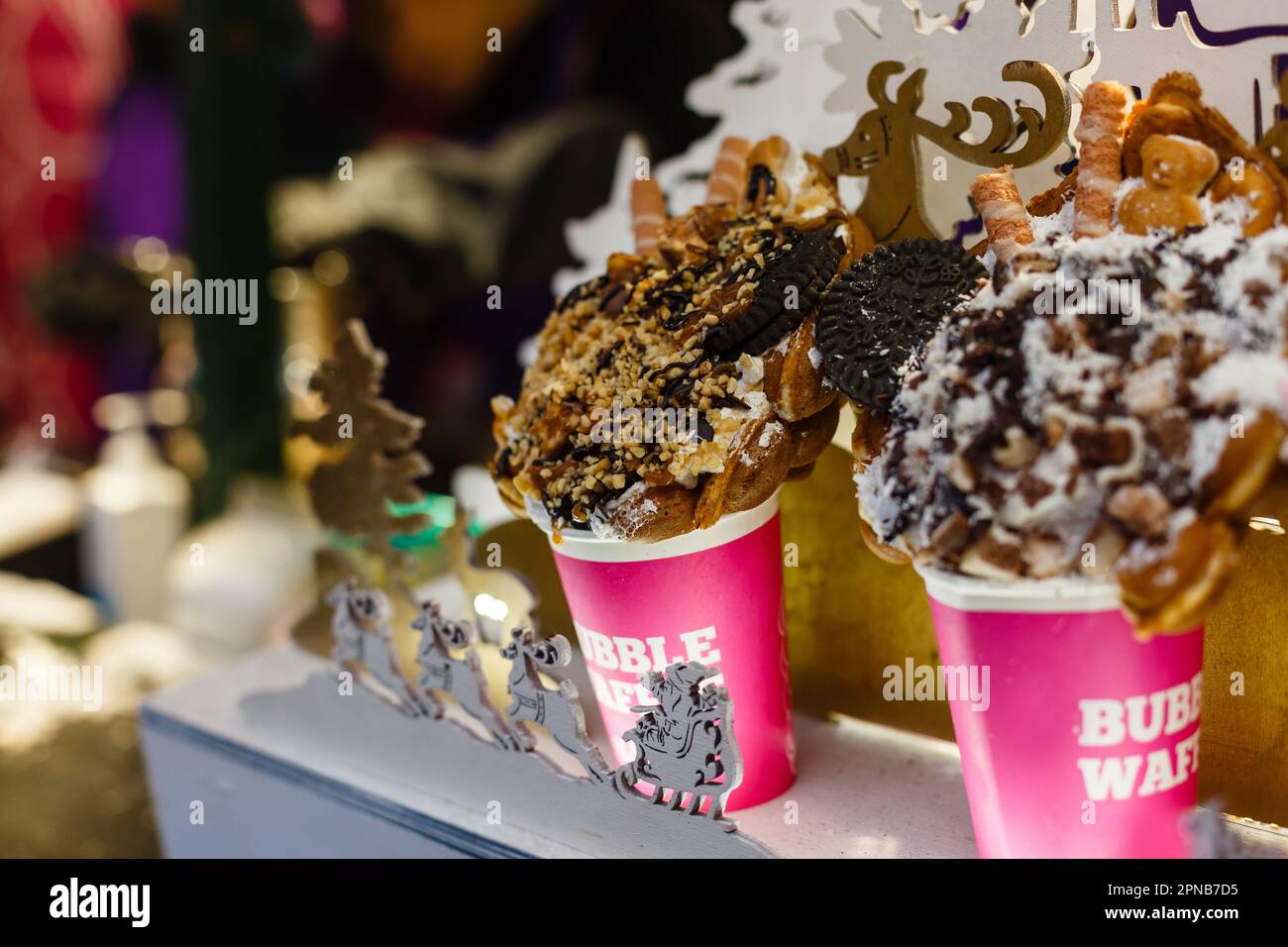 Delicious traditional waffles with whipped cream on display in a store ...