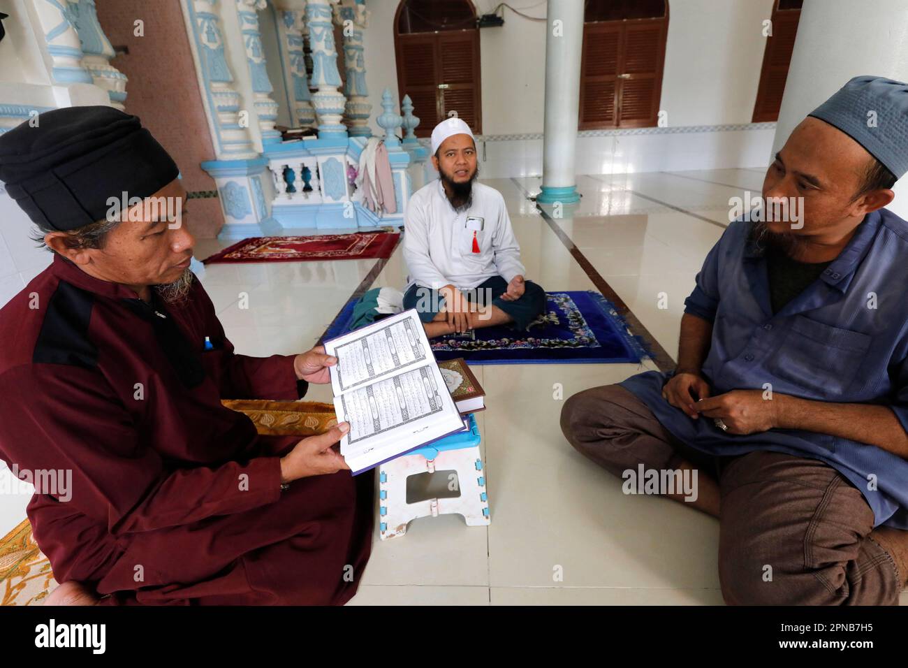 Masjid Nia'mah mosque. Muslim men reading the Holy Quran. Chau Doc ...