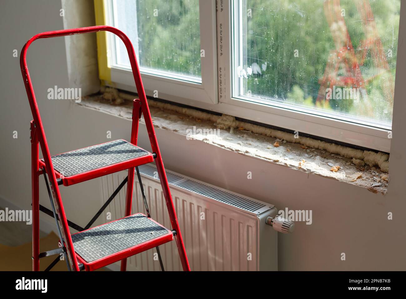 Installation of windows. Polyurethane foam on the slope of the window ...