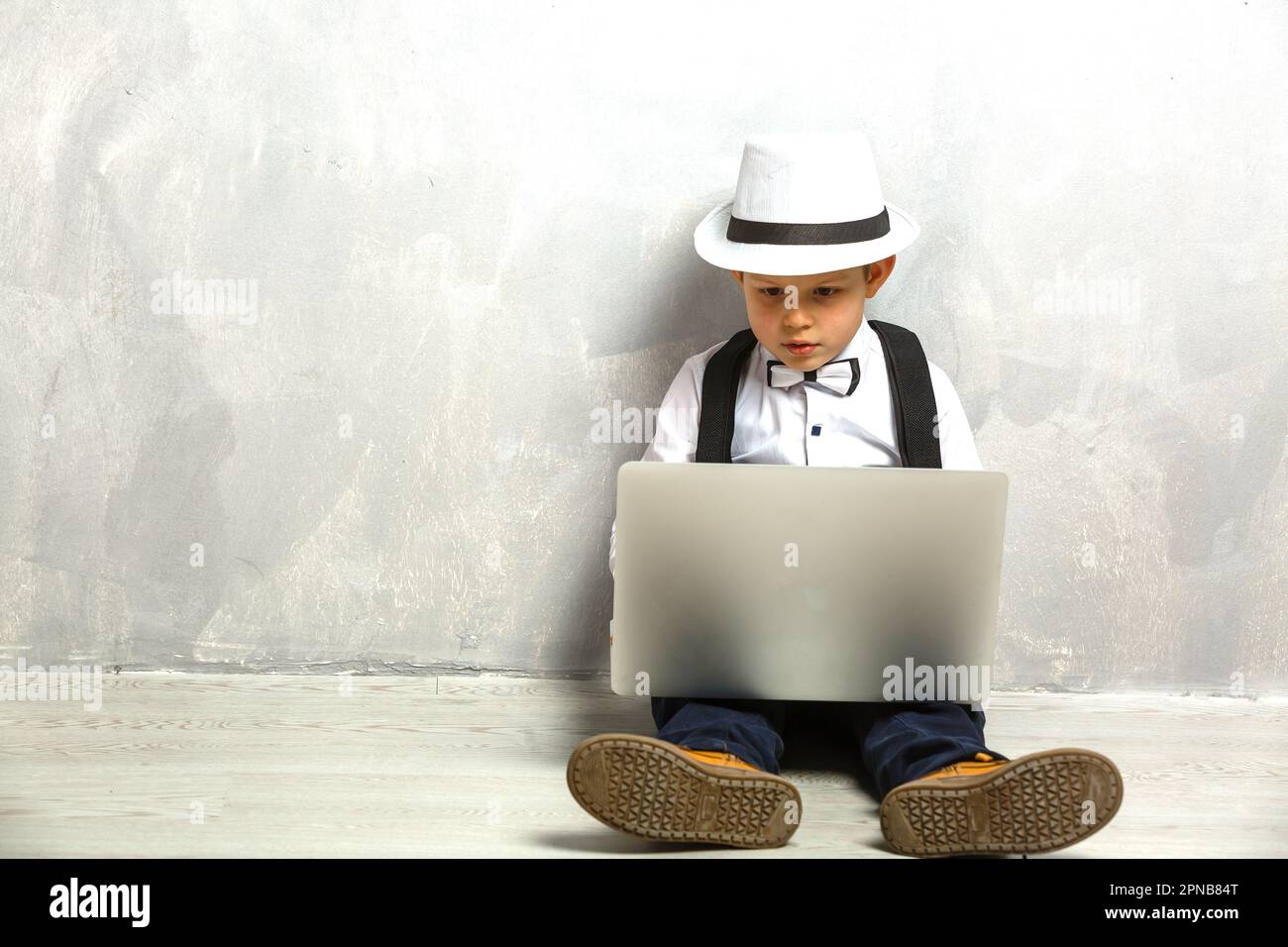 Portrait of Genius. Young boy working on the computer sitting On the ...