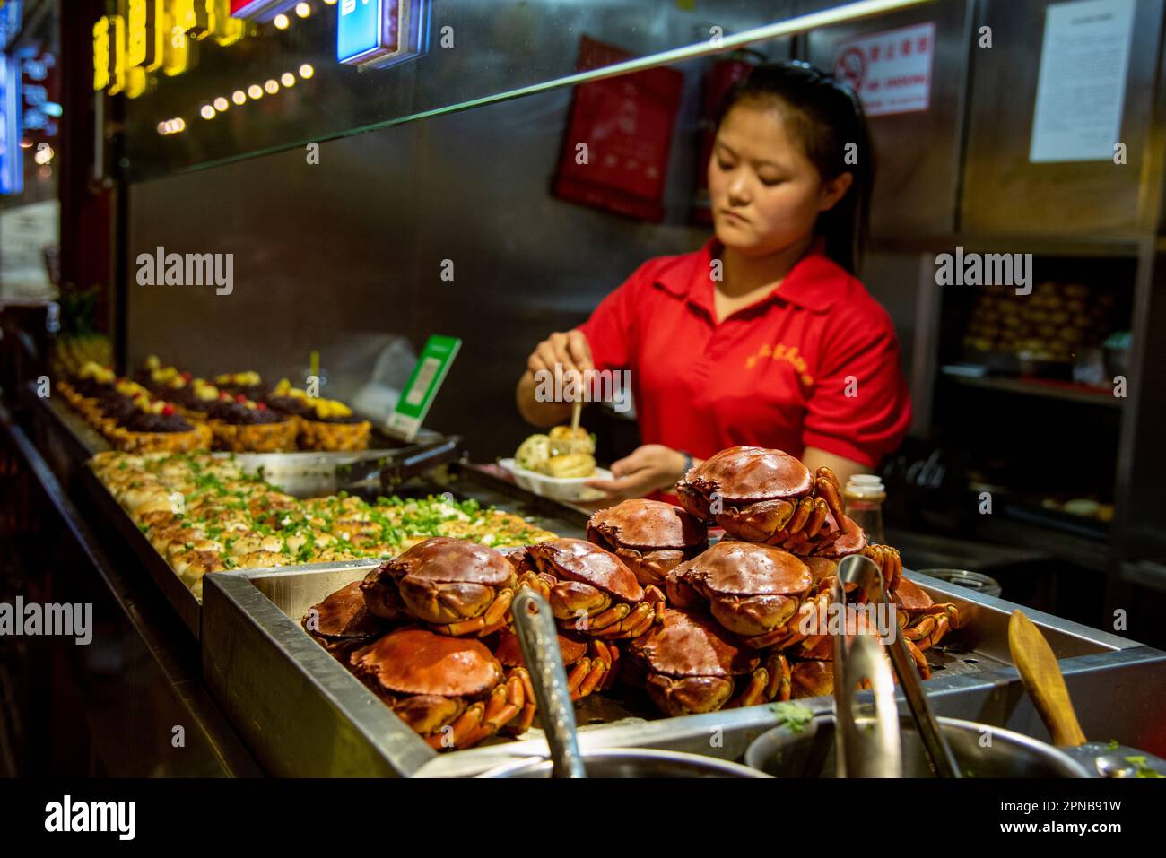 Chinese chef cooking traditional on the snack street in Beijing China ...