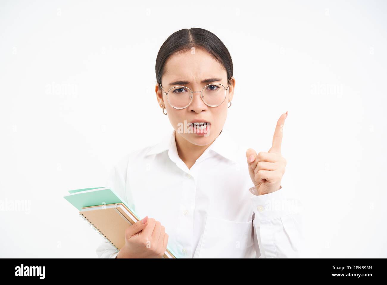 Disappointed, serious japanese teacher, woman shakes finger in ...