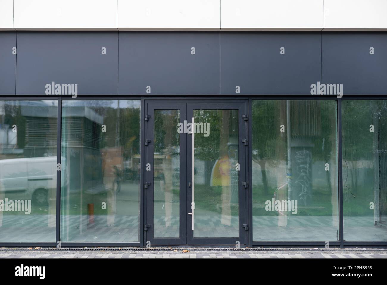 Outside solid glass door with building exterior Stock Photo - Alamy