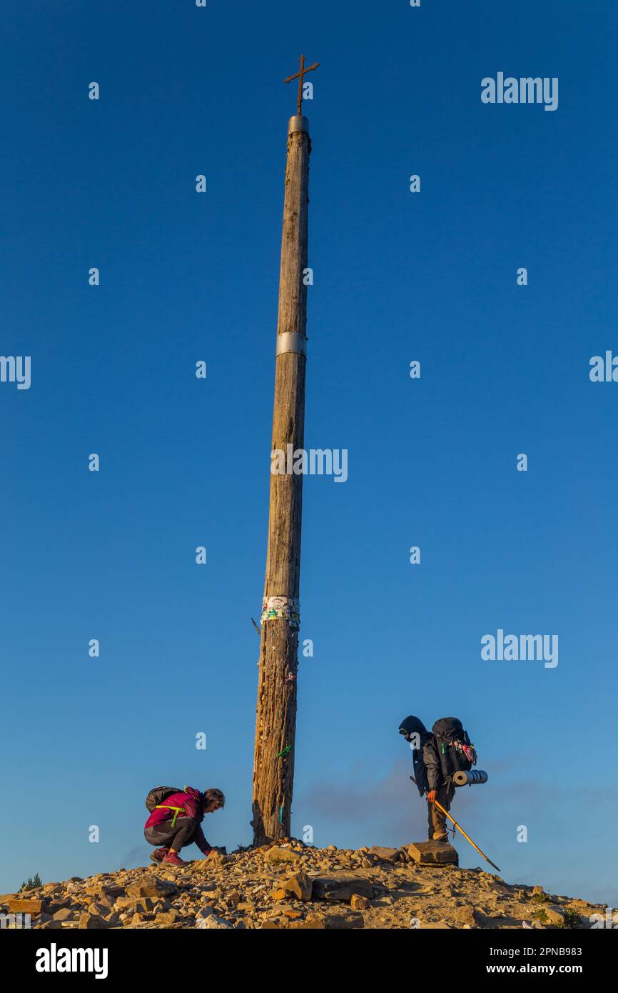Foncebadon, Spain - 20 August 2022: Pilgrims next to the iron cross ...