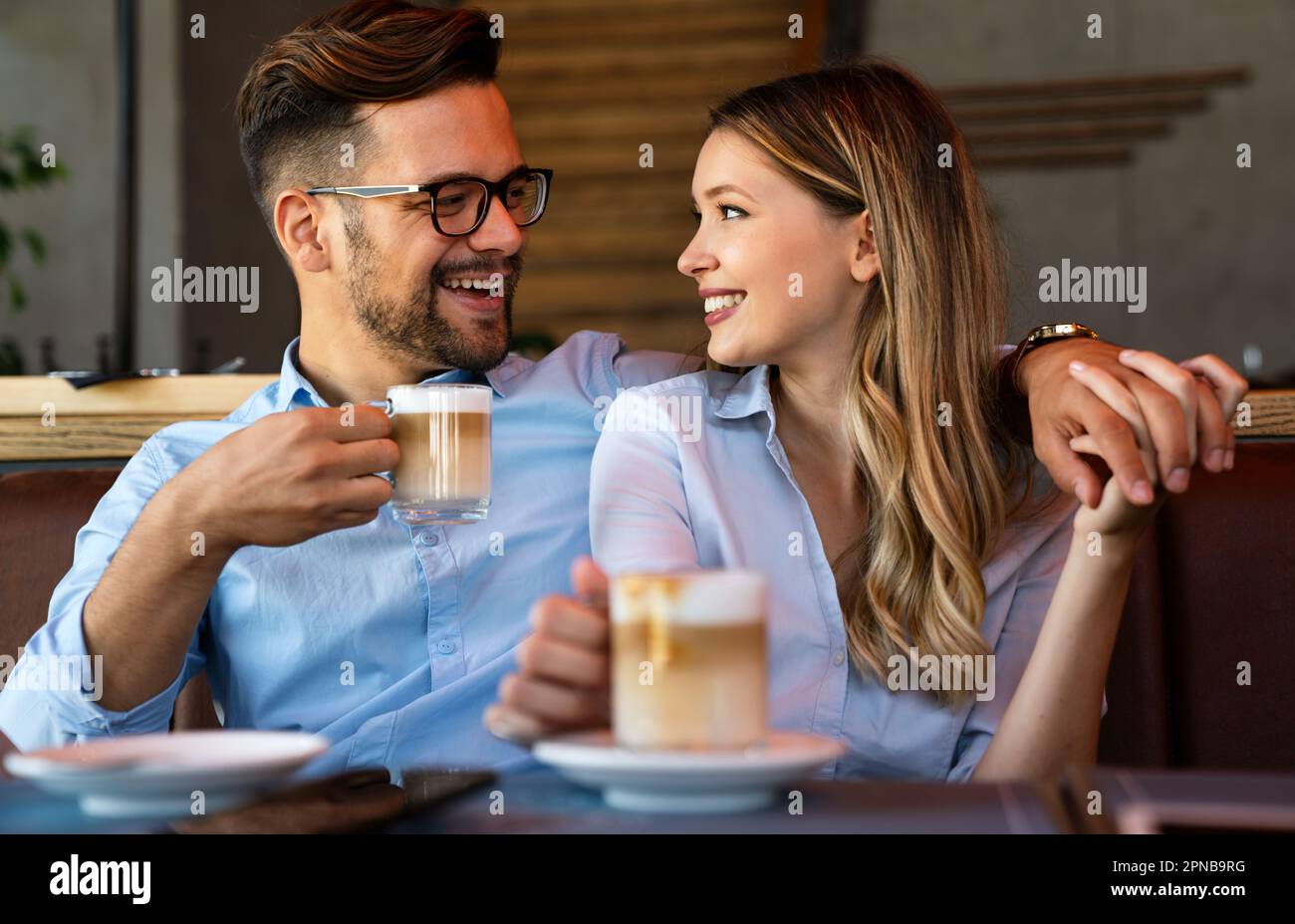 Romantic loving couple drinking coffee, having a date in the cafe Stock ...