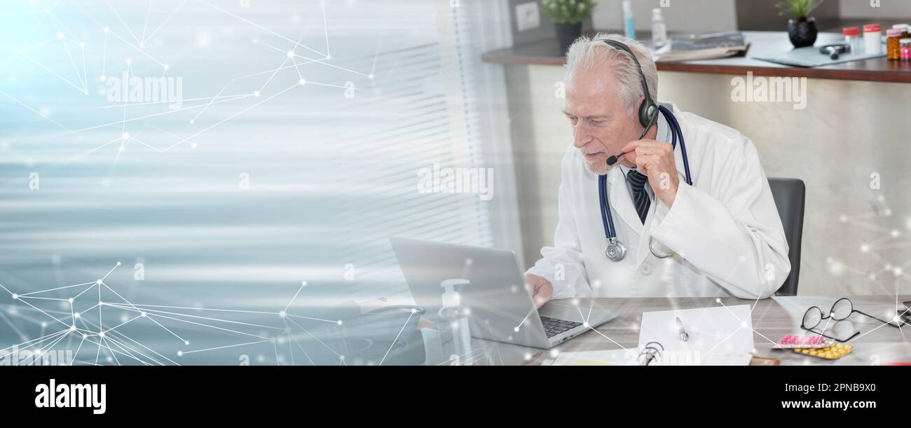 Portrait of senior doctor during online medical consultation; panoramic ...
