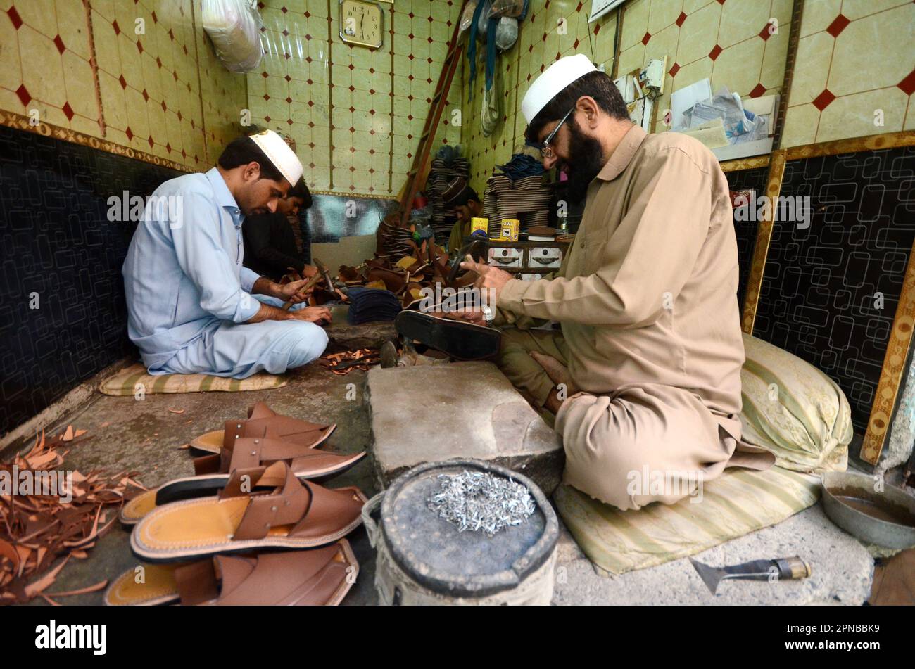 A Pakistani cobbler makes traditional Peshawari Chappal shoes ahead of ...