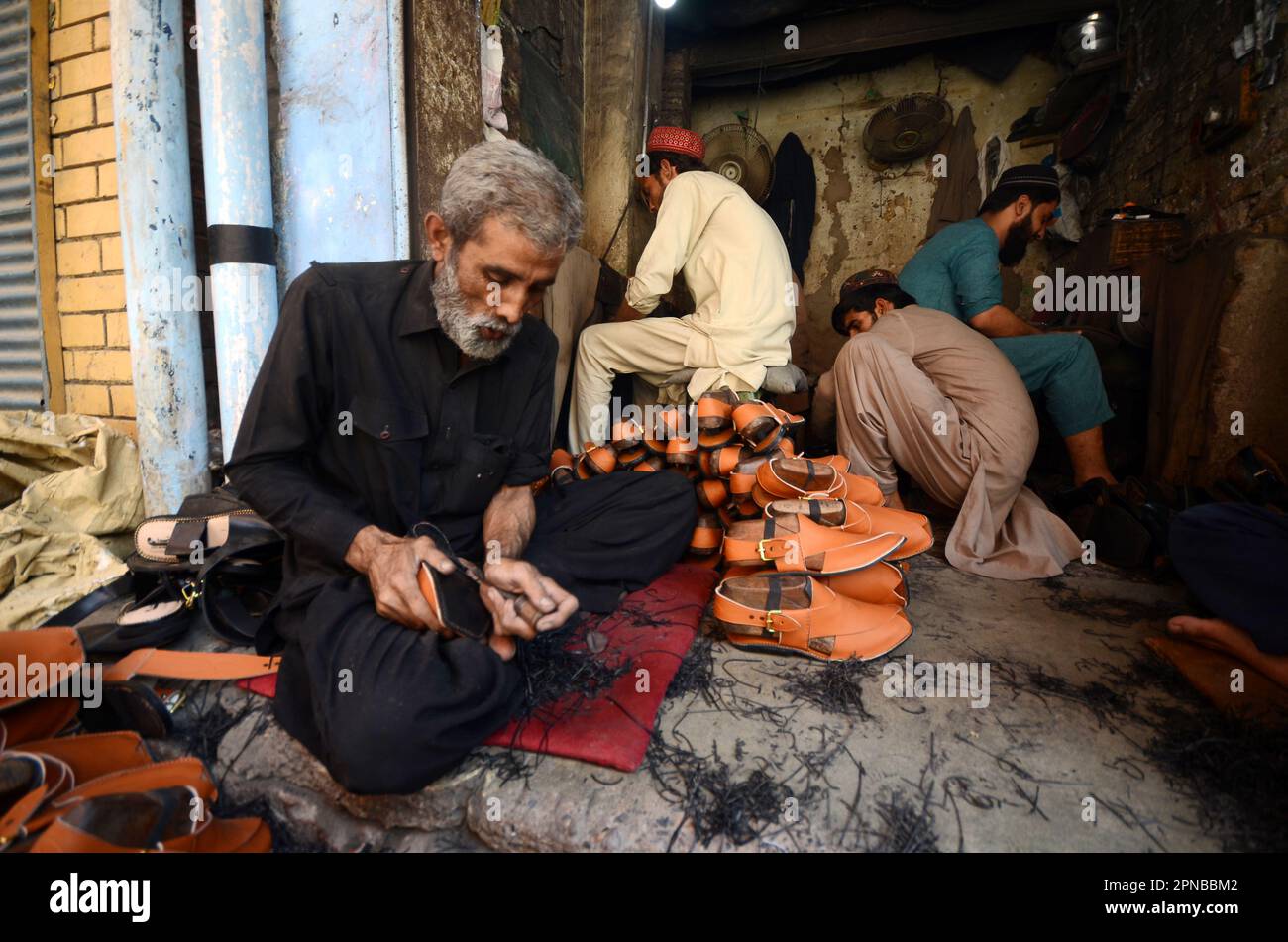 A Pakistani cobbler makes traditional Peshawari Chappal shoes ahead of ...